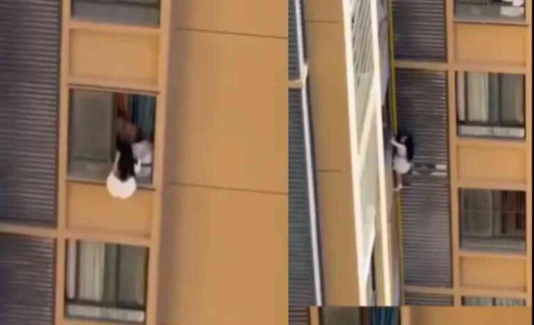 Mujer escapa por la ventana de un edificio